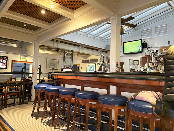 The bar area channels old-school yacht club vibes, where every stool tells a story and the bartenders know most of them.