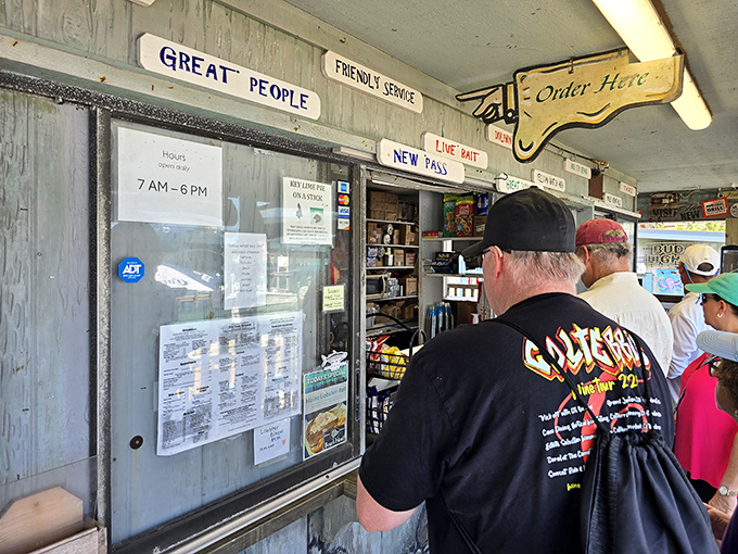 Signs that tell you everything about a place's character. "Great People, Friendly Service" isn't just wall decor, it's the New Pass philosophy.