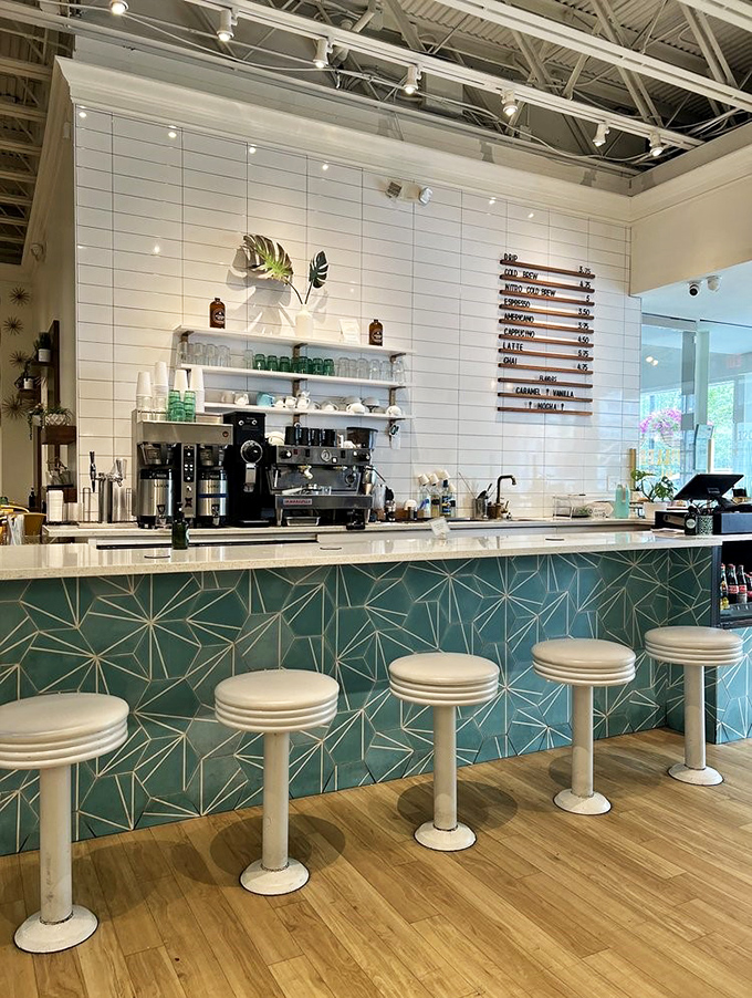 The counter's geometric teal tiles and sleek white backdrop create a retro-modern stage for breakfast theater that plays all day.