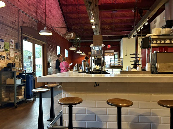 Cozy brick walls and pendant lighting create the kind of atmosphere where great conversations naturally unfold.