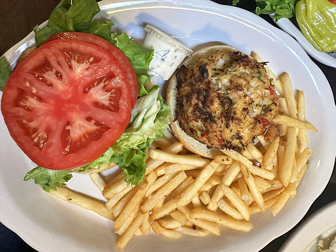 A sandwich that celebrates the sea &ndash; golden crabcake, fresh tomato slice, crisp lettuce, and fries that could steal the show if the crabcake wasn't so magnificent.