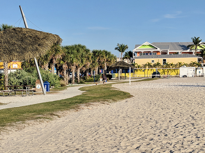 Tiki huts and palm trees frame this perfect stretch of beach. Mother Nature showing off again with that impossibly blue water meeting powder-white sand.