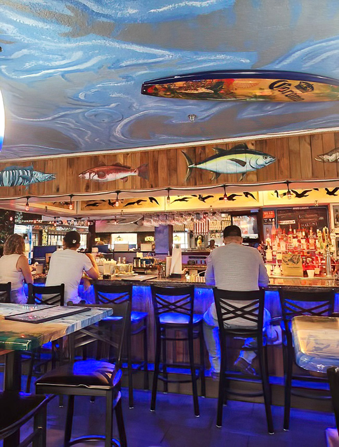 The bar area, with its surfboard-adorned ceiling and fish murals, captures Florida's coastal vibe without resorting to tacky beach clich&eacute;s.