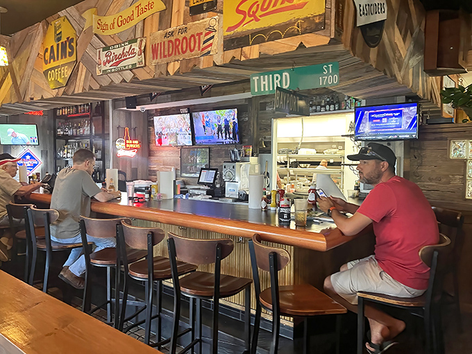 Where vintage signs meet modern sports screens, creating that perfect "third place" where locals and visitors find common ground over cold drinks.
