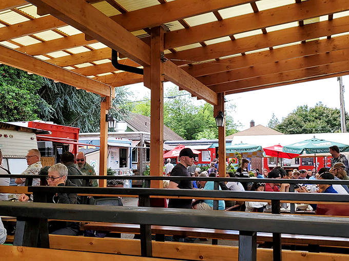 The universal language of barbecue brings strangers together at wooden tables. Notice how nobody's talking? That's the sound of meat-induced happiness.