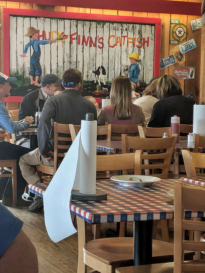 Diners enjoying their meals beneath a charming mural that captures the restaurant's namesake. No phones in sight&mdash;just people connected by good food and conversation.