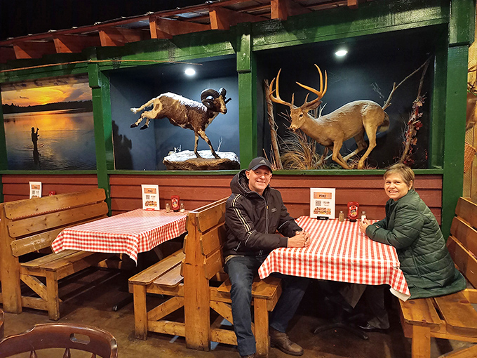Diners enjoying their meal beneath taxidermied wildlife &ndash; because nothing says "authentic outdoors experience" quite like eating with nature's observers.