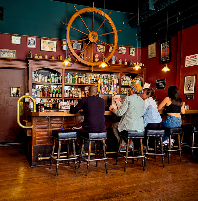 The bar area combines nautical charm with serious drinking. That ship's wheel overhead ensures your evening stays on course.