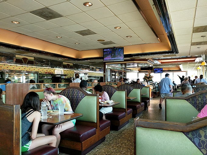 The quintessential diner experience: strangers united by vinyl booths and the universal language of "pass the ketchup, please."