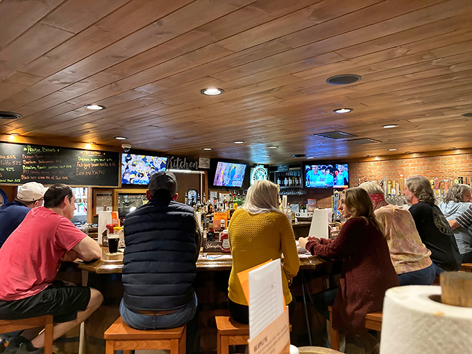 Locals gather at the bar, perhaps discussing strategies for tackling the infamous Belly Busters or simply enjoying the convivial atmosphere.