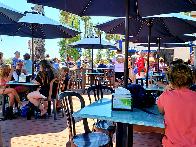 Generations gather under coastal sunshine, united in the universal language of "mmm" and "you've got to try this."