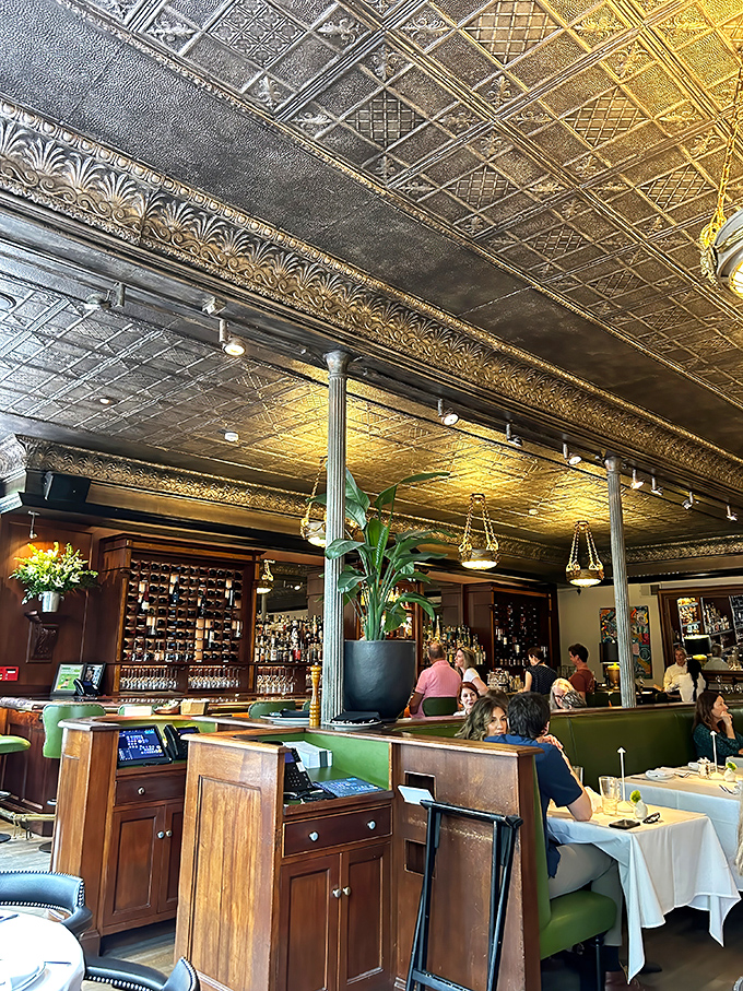 The ornate tin ceiling has witnessed countless celebrations, first dates, and the silent prayer of "please let there be room for dessert."