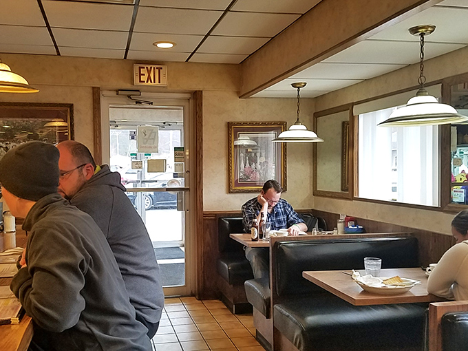 The quintessential diner booth experience—where strangers become neighbors and everyone's connected by the universal language of good food.