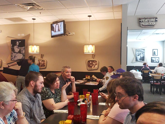 Where strangers become neighbors over plates of comfort food. Notice how nobody's looking at their phones? That's the Oscar's effect.