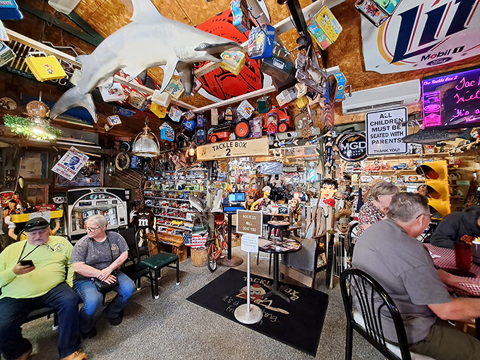 Locals gather under a ceiling of treasures, proving that the best dining companions are those who appreciate no-frills perfection.