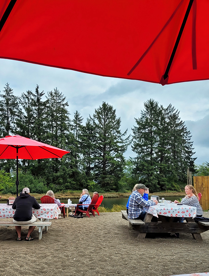 Red umbrellas dot the landscape like exclamation points, sheltering diners enjoying the perfect pairing: fresh seafood and Oregon's natural splendor.
