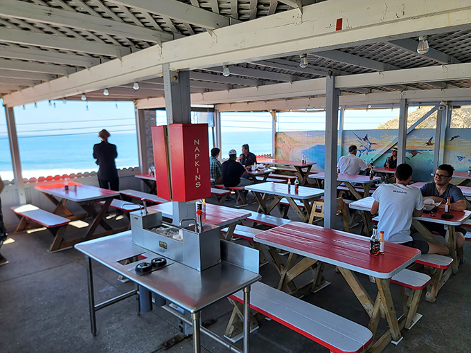 Diners enjoy their seafood feast under covered seating with those iconic coastal mountain views. 