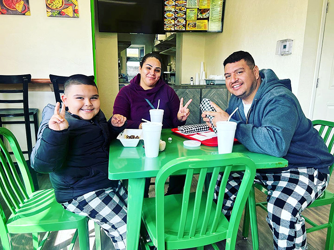 Happy diners making memories over meals. This is what it's all about&mdash;food bringing people together around a bright green table.