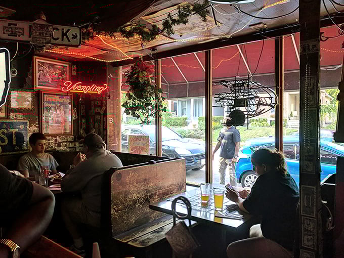 Weathered wooden booths cradle conversations and laughter as sunlight streams in, illuminating the timeless ritual of breaking bread together.