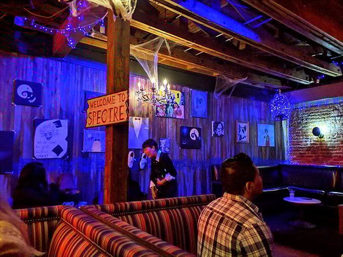 "Welcome to Spectre" indeed—this blue-lit corner feels like you've wandered into a movie set where the cocktails are real but reality is optional.