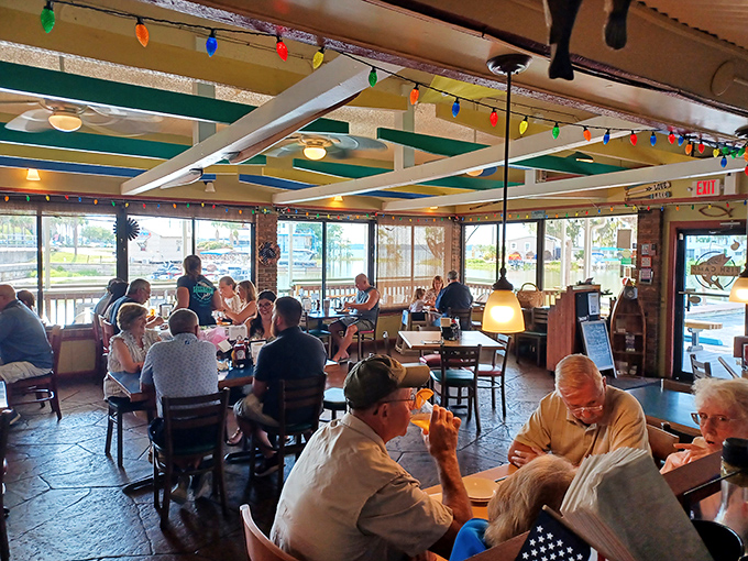 Where locals gather to share stories as freely as condiments. The colorful string lights overhead match the vibrant conversations below.