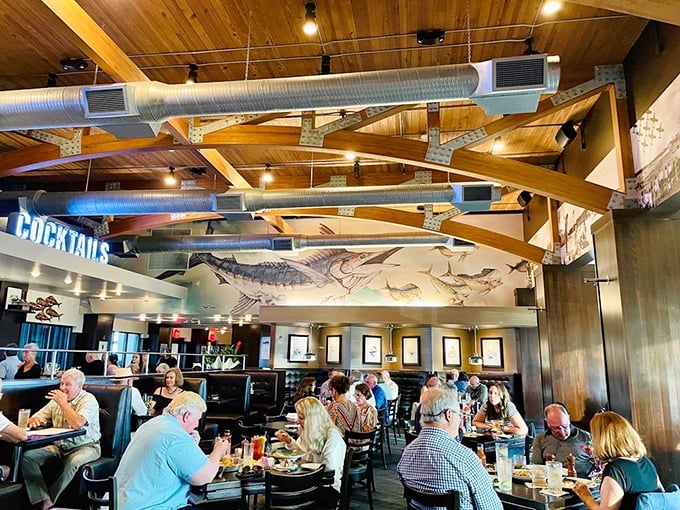 Where seafood enthusiasts gather under wooden beams adorned with marine artwork. The fish on the wall is the only one not destined for your plate.