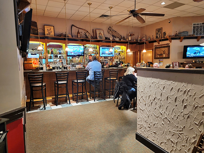 The bar area offers front-row seats to culinary magic, where strangers become friends over shared recommendations and second rounds.