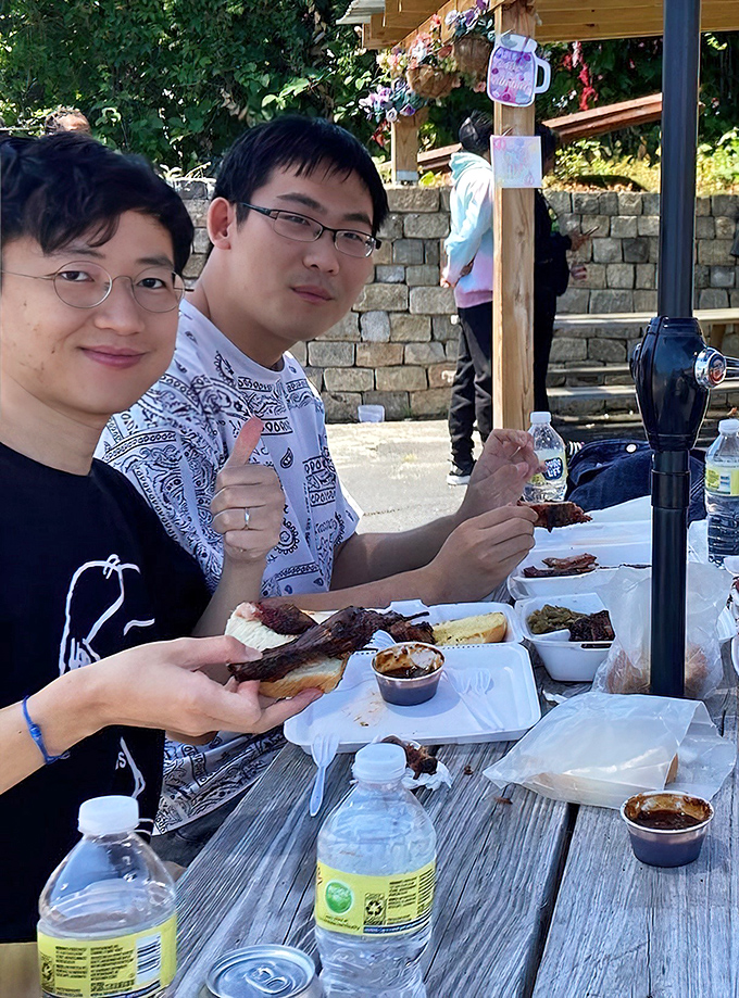 Happy diners giving thumbs up&mdash;the universal sign language for "this barbecue has temporarily rendered me incapable of forming words."