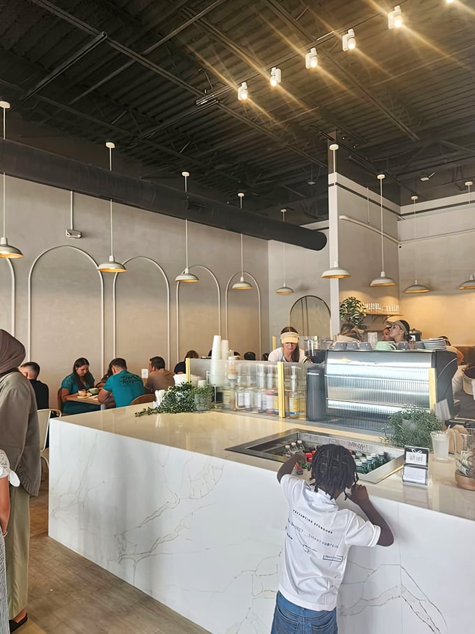 The bustling counter scene where pastry dreams come true. That marble countertop has witnessed countless moments of pure dessert joy.