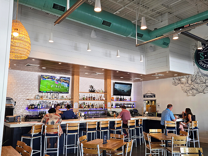 The bar area invites lingering over oysters and stories—where "just one more" applies equally to both drinks and seafood towers.