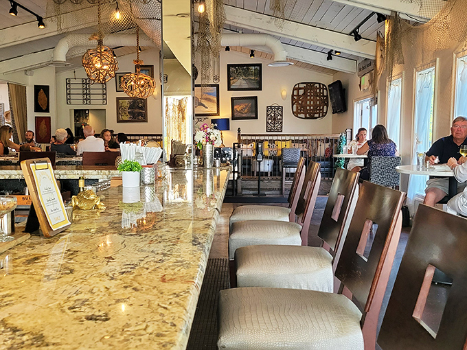 The bar area invites lingering conversations and spontaneous friendships. Where strangers become dining companions over shared food recommendations.