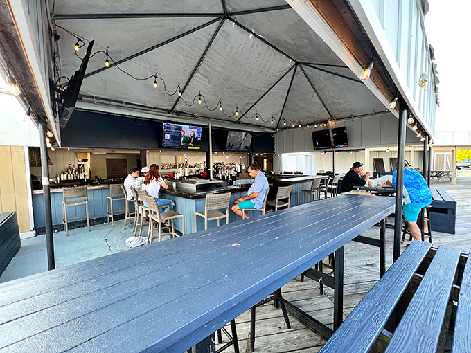 The covered outdoor bar area invites lingering over cold drinks and hot gossip. Maryland sports memorabilia reminds you exactly where these crabs call home.