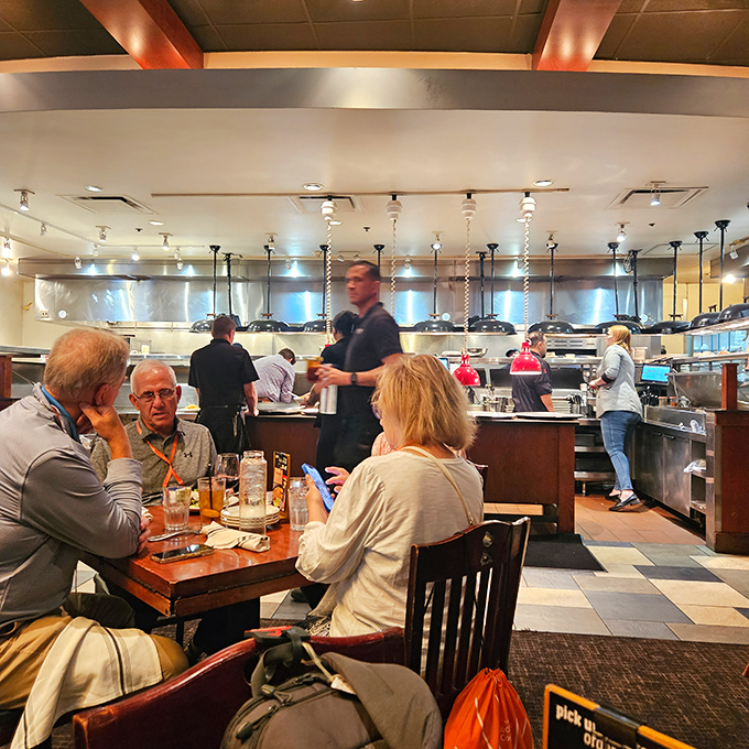 The open kitchen concept turns dinner into dinner theater, with chefs performing culinary magic while diners enjoy the best seats in the house.