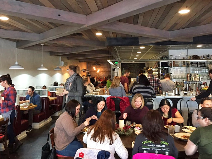 A full house of happy diners&mdash;the universal sign of "you've chosen wisely." The wooden beams frame a symphony of forks meeting plates.