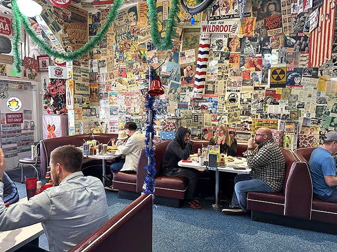 The booths where strangers become friends over pancakes. Red vinyl seating cradles diners while walls plastered with mid-century ephemera provide endless conversation starters.