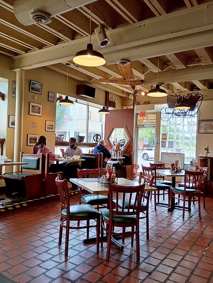 Morning light streams through those magnificent arched windows, creating the perfect backdrop for conversations that turn strangers into regulars.