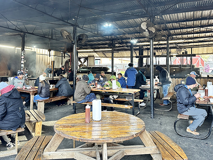 The covered outdoor seating area—where strangers become temporary friends united by the universal language of "mmm" and "pass the napkins, please."