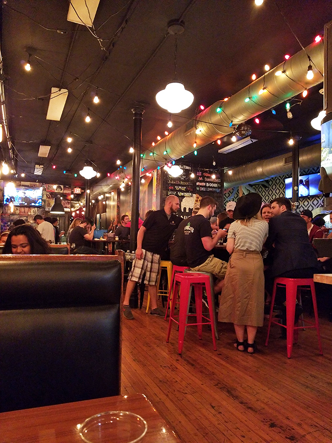 Under the glow of string lights and colorful bulbs, strangers become friends, united by the universal language of exceptional pizza.