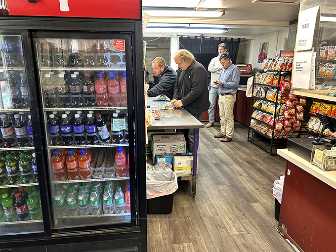The prep counter scene – where hungry patrons wait with the patience of saints for packages of smoky treasure that justify every minute.
