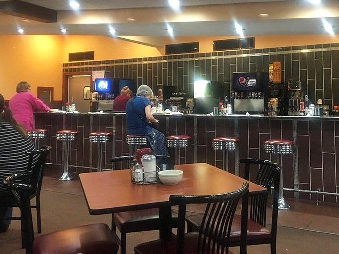 The classic diner counter&mdash;where solo diners find community, regulars claim their territory, and the coffee never stops flowing.