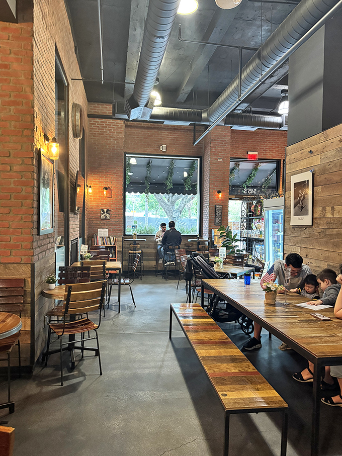 Industrial chic meets warm hospitality. The exposed ceiling and brick walls create a space where lingering is not just allowed but encouraged.