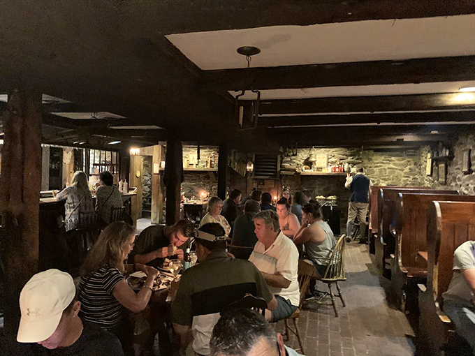 The tavern's lower level buzzes with energy and stories. These stone walls have heard centuries of conversations, and tonight's diners are adding their own chapter.
