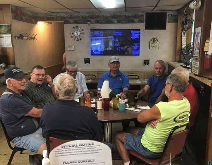 The morning roundtable where local wisdom is exchanged over coffee cups that never stay empty for long.
