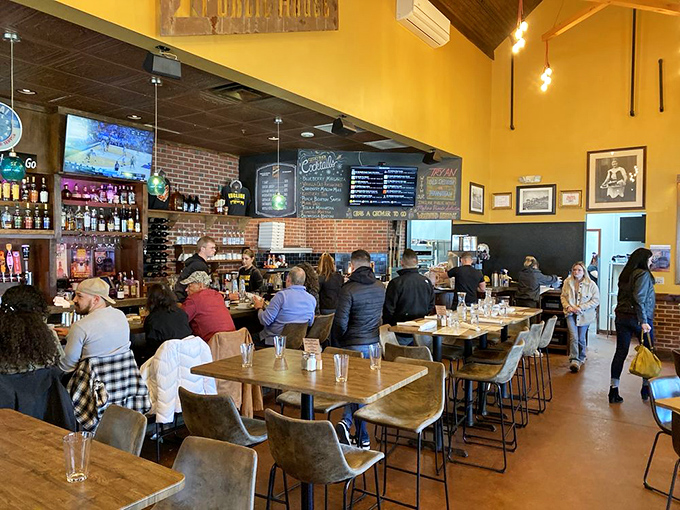 The buzz of happy diners fills this welcoming space where every table tells a story of satisfied appetites.