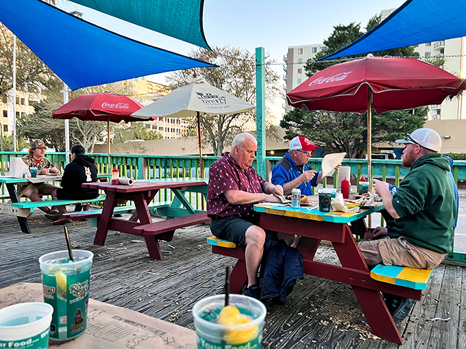 The outdoor deck where vacation time slows down. Three guys, three burgers, and absolutely zero hurry to be anywhere else.