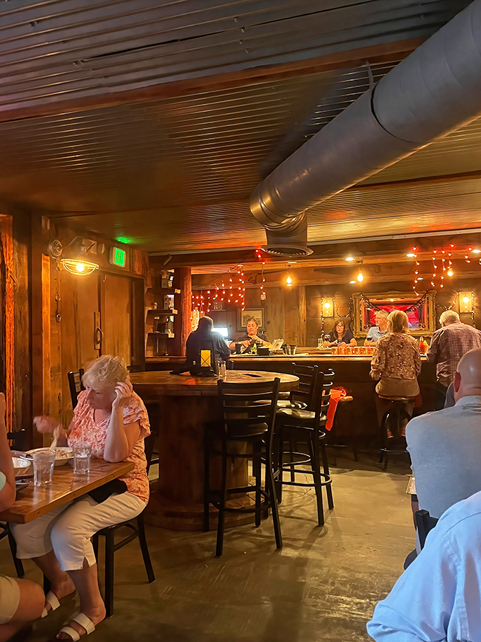 The bar area hums with conversation and anticipation, where strangers become friends united by the universal language of great food.