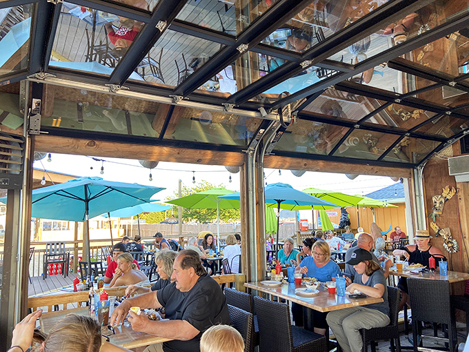 Overhead glass panels blur the lines between indoor comfort and outdoor lakeside dining bliss.