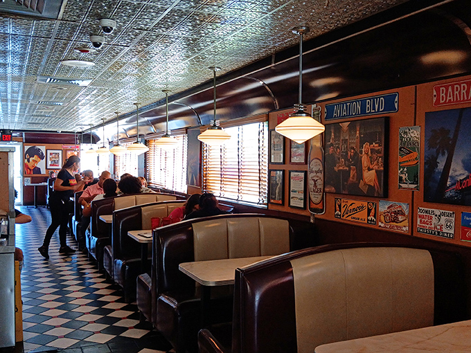 Booths designed for comfort and conversation. The vintage posters aren't just decoration&mdash;they're silent witnesses to countless first dates and family celebrations.