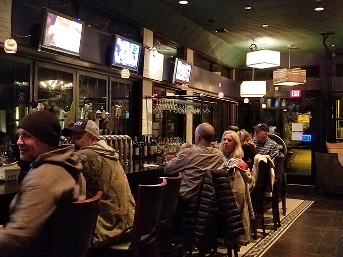 The bar buzzes with conversation, where strangers become friends over perfectly poured pints and stories.