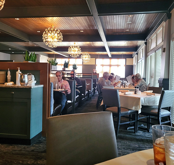 Happy diners enjoying their meals create the kind of warm atmosphere that makes every visit feel like coming home.